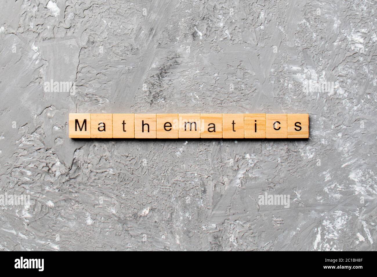 mathematics word written on wood block. mathematics text on cement ...
