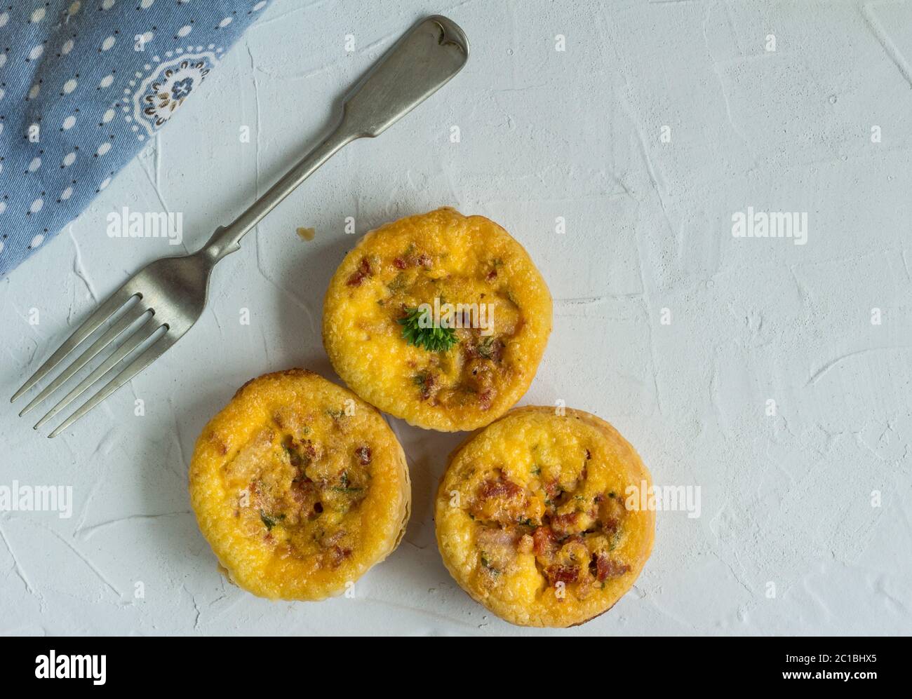 Quiche Lorraine backround, top view of three mini tartlets closeup on ...