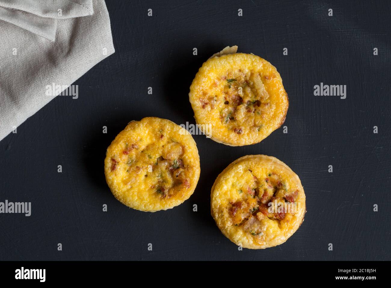 Quiche Lorraine backround, top view of three mini tartlets closeup on ...