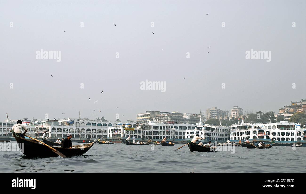 Sadarghat in Dhaka, Bangladesh. Many small boats crossing the river at ...