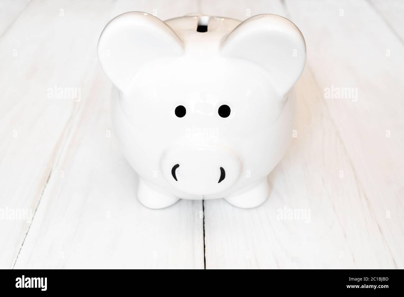 Front view of white piggy bank Stock Photo - Alamy