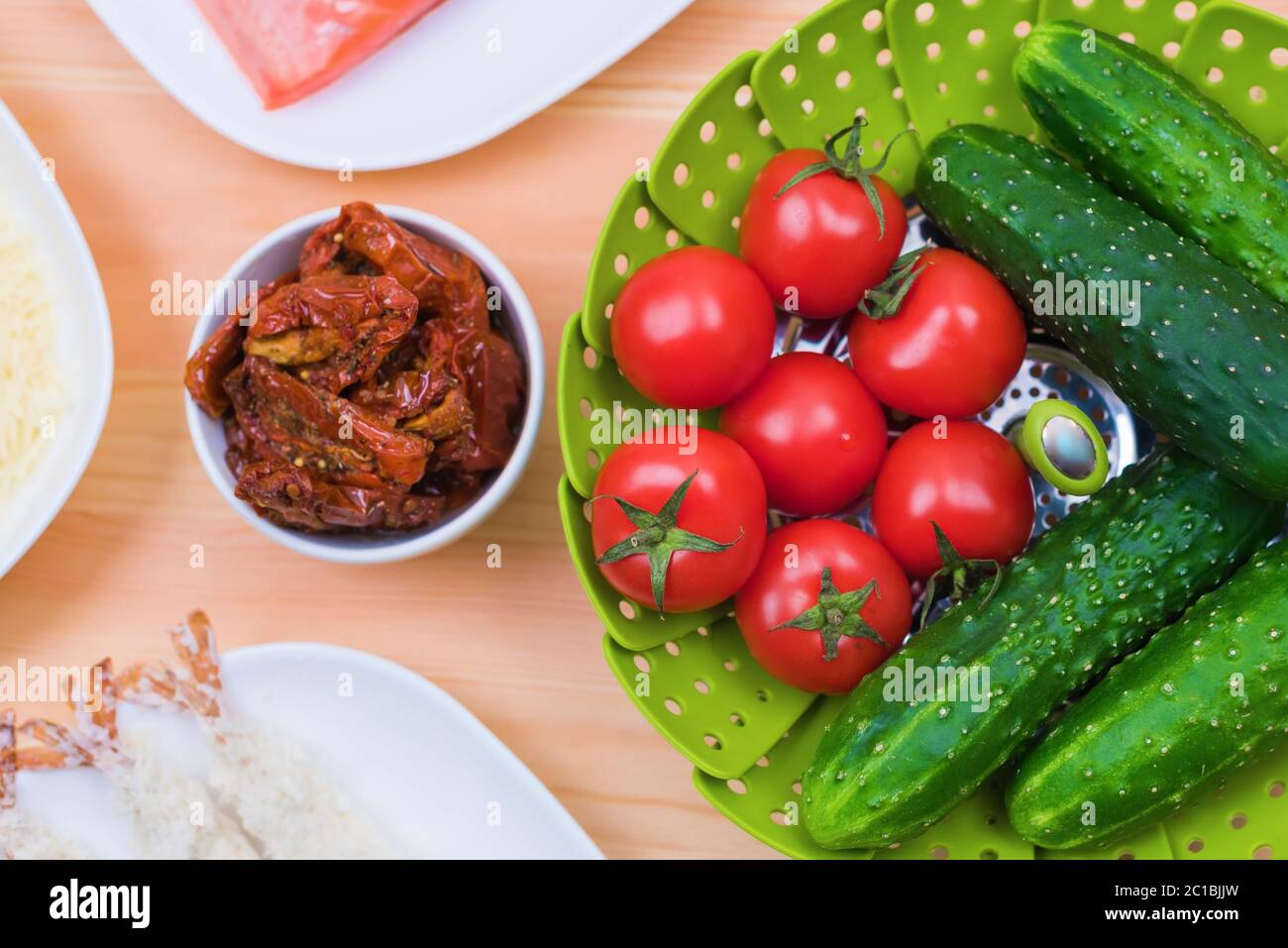 Still life of raw food in white plates on a wooden table. Frozen salmon ...