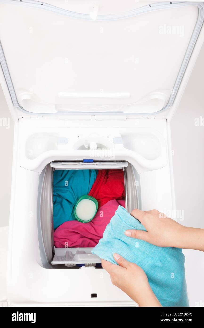Washing machine loaded with clothes Stock Photo - Alamy