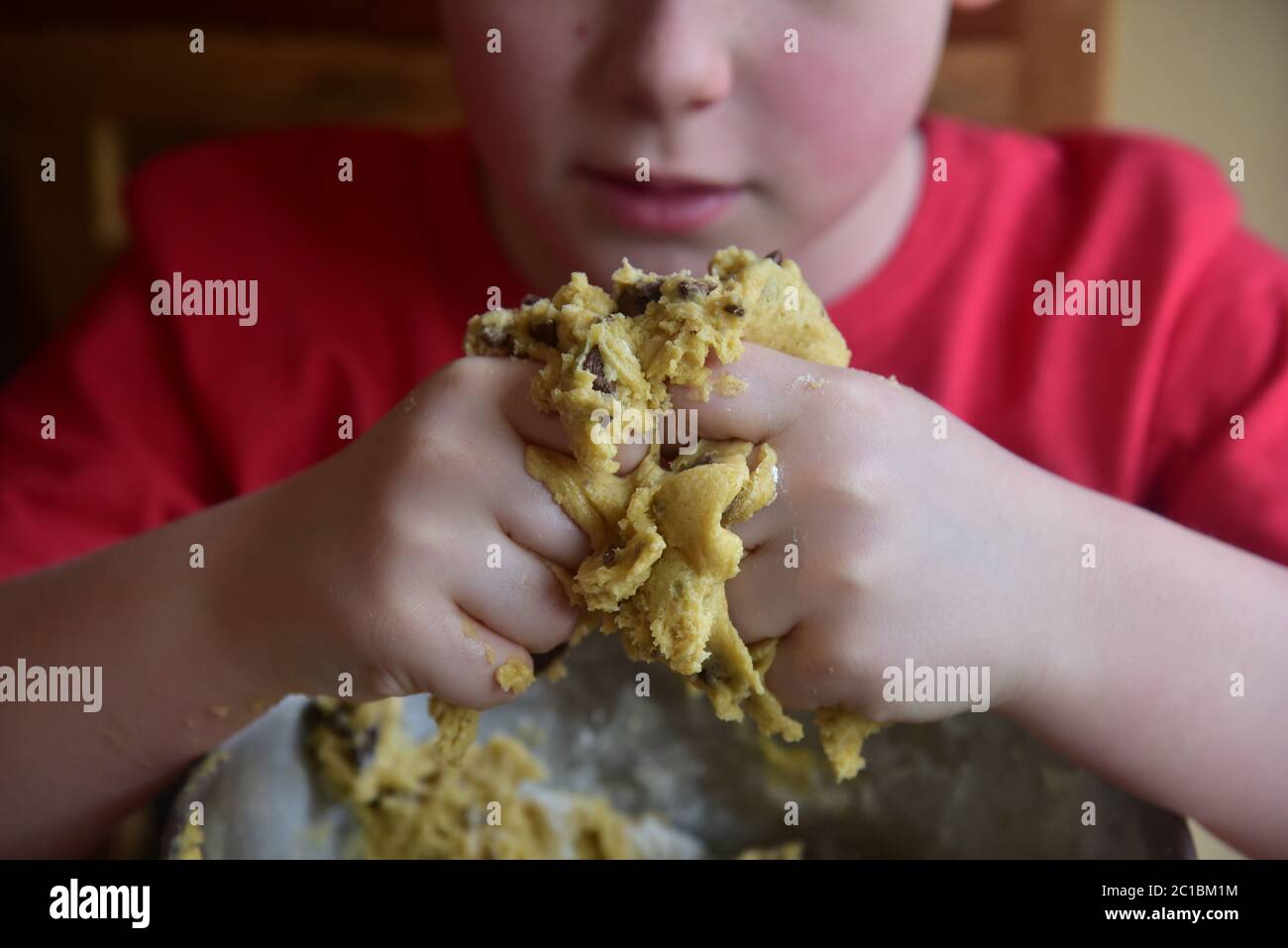 A primary school pupil is pictured baking chocolate chip cookies as ...
