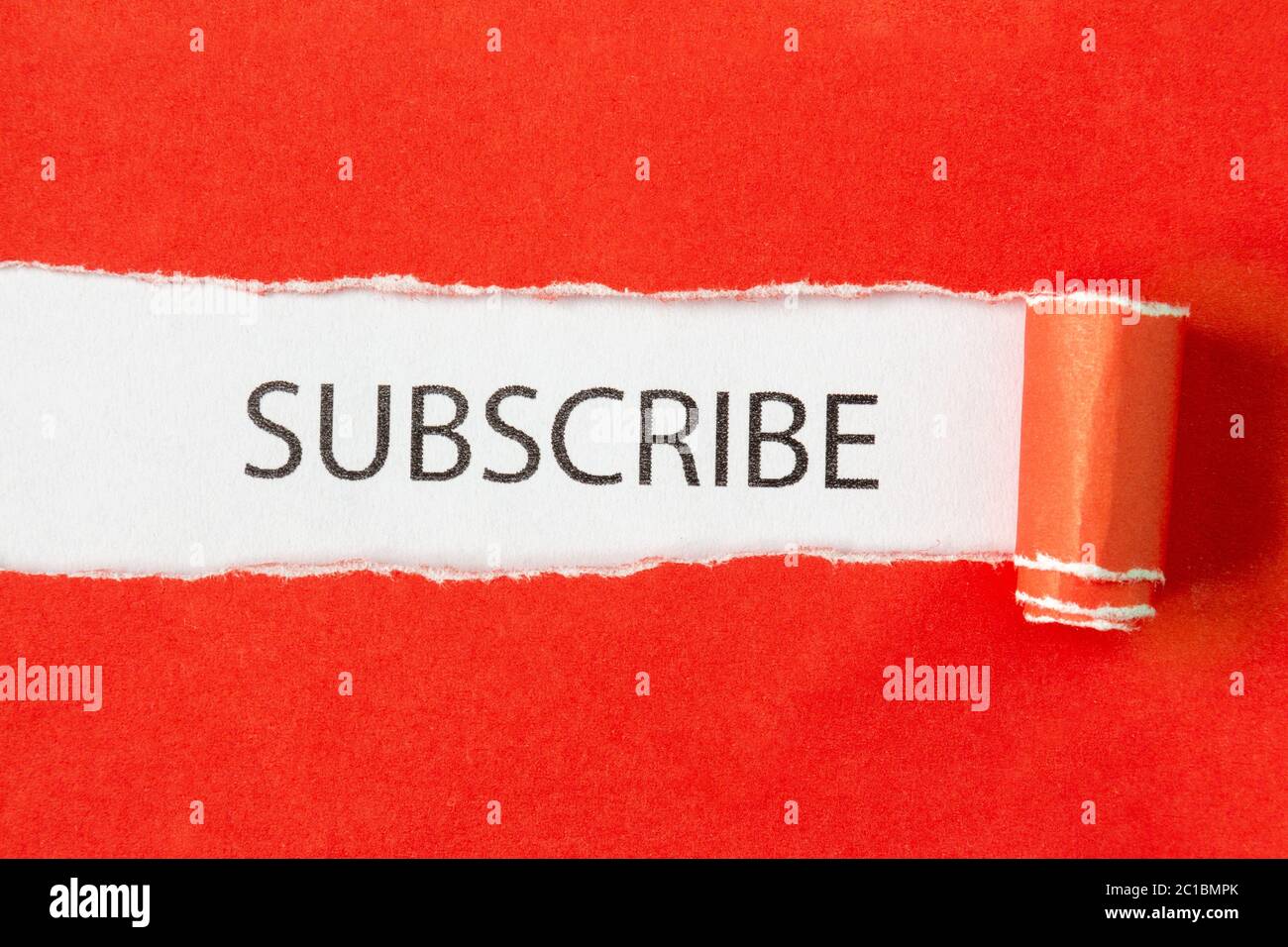 Subscribe Word on torn paper Stock Photo - Alamy