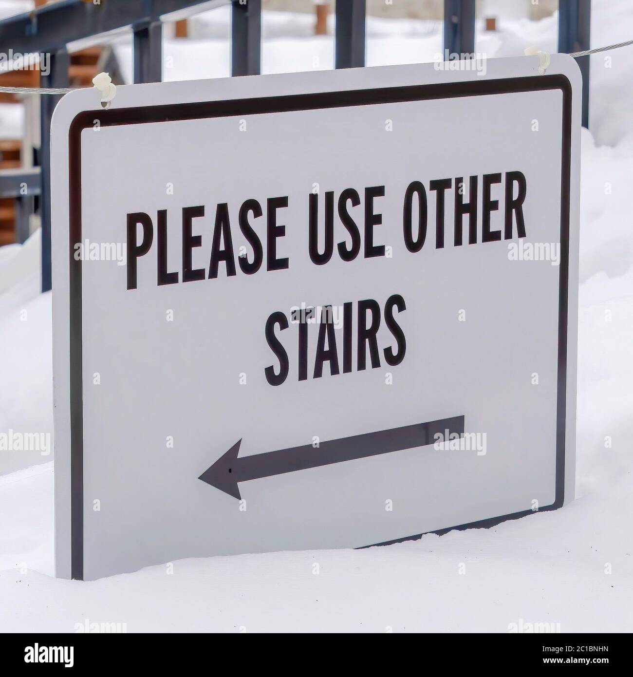Square Stairs buried in winter snow with sign that reads Please Use ...