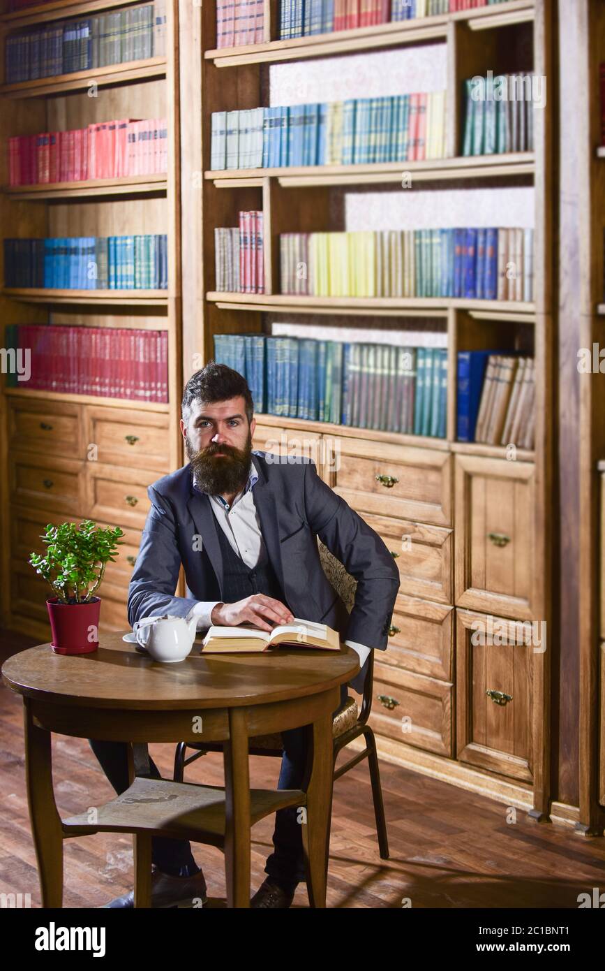 Elite lifestyle concept. Aristocrat on smiling face holds book. Man in ...