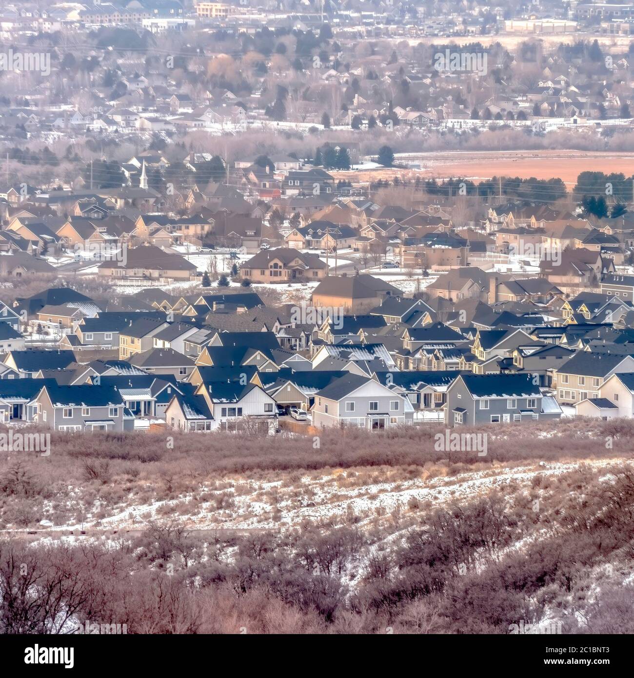 Square Houses in Alpine Utah neighborhood amid snowy hill and abundant ...