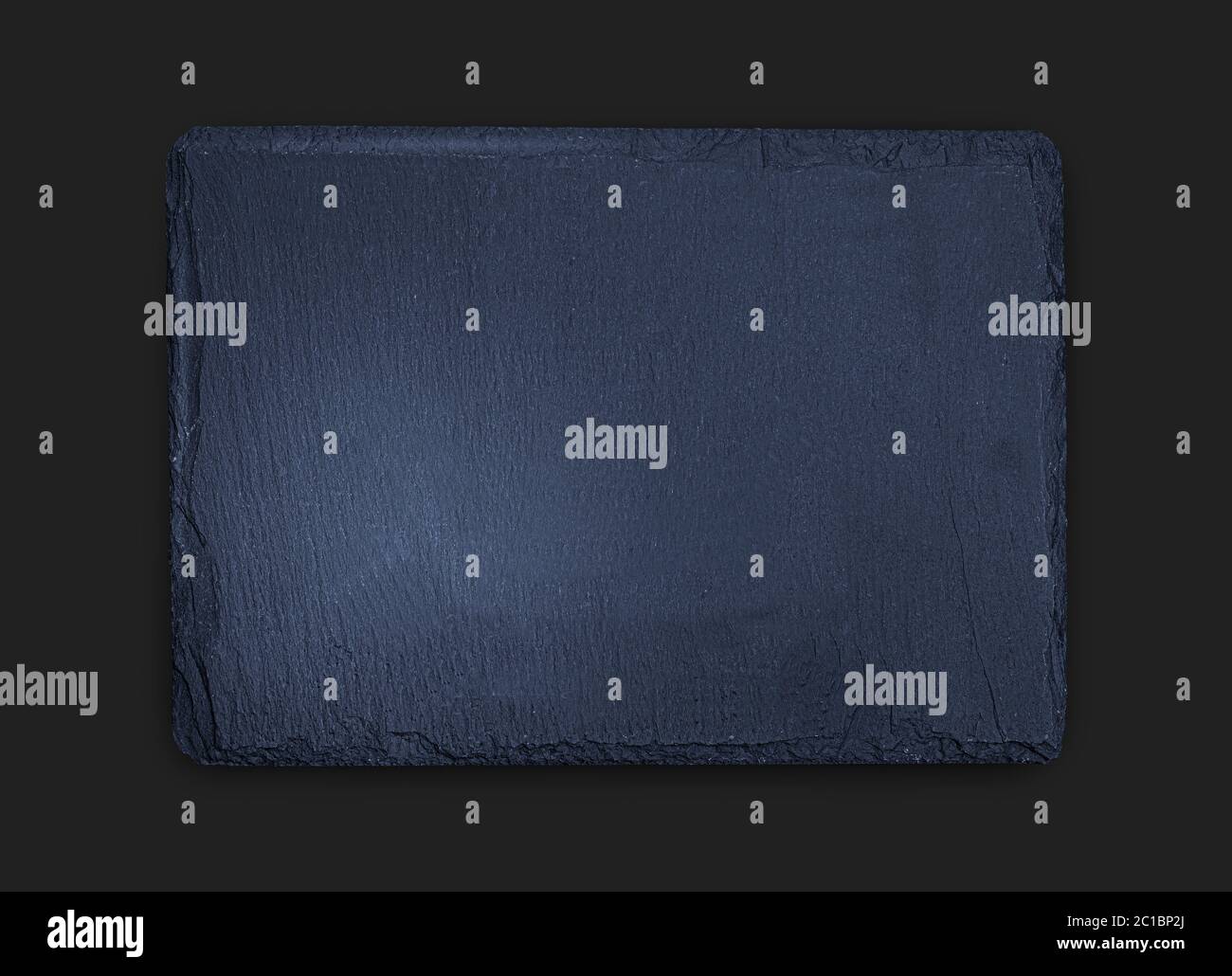 Gray slate board on black wooden table close up photo, natural texture ...