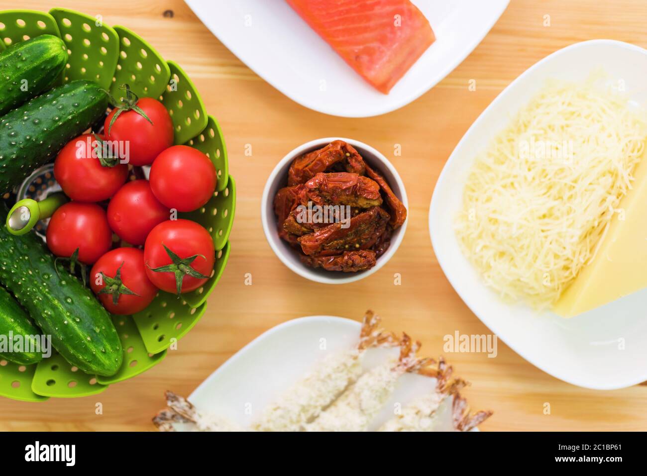 Still life of raw food in white plates on a wooden table. Frozen salmon ...