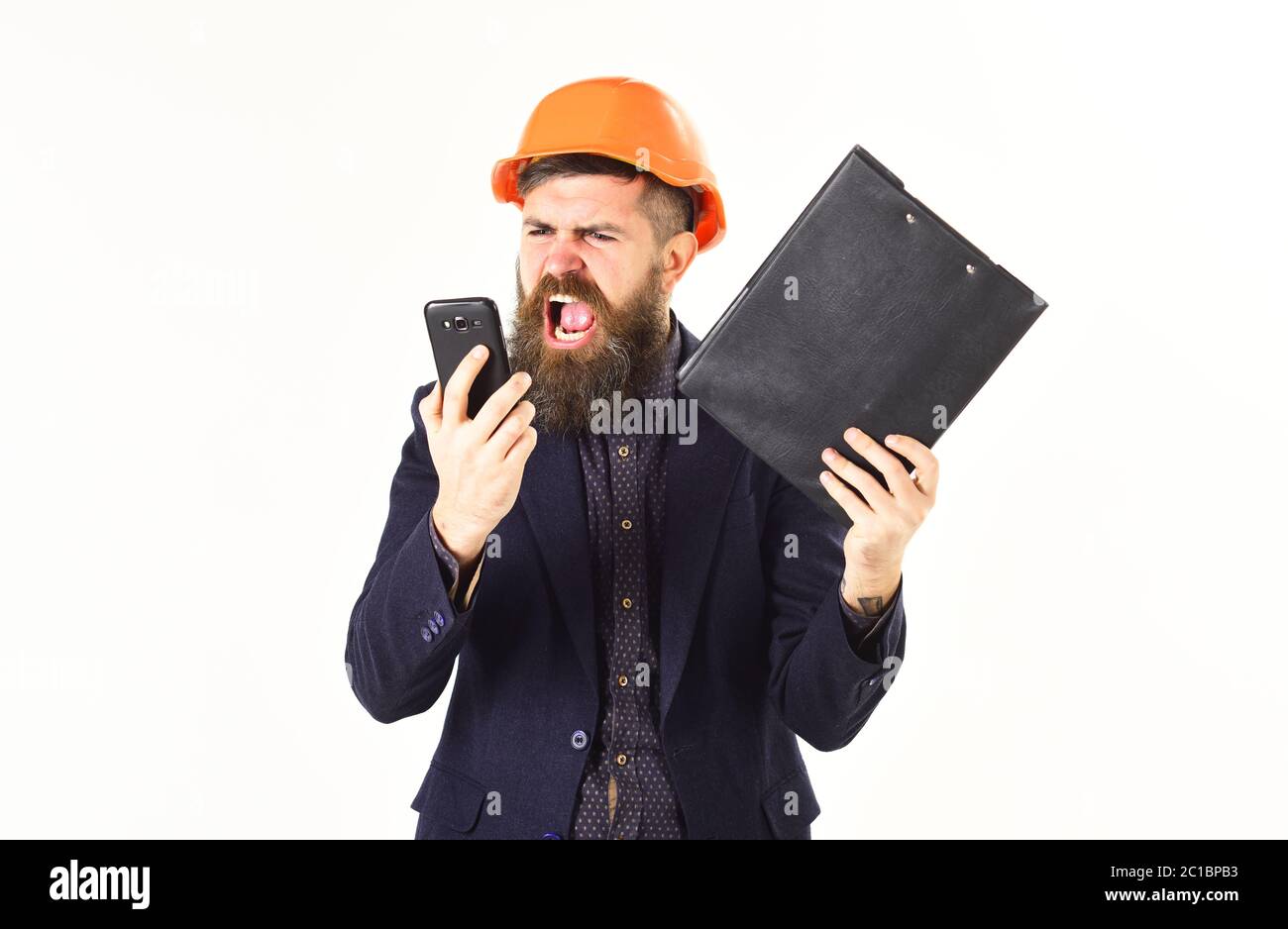 Angry builder or constructor yelling at somebody on phone as fury ...
