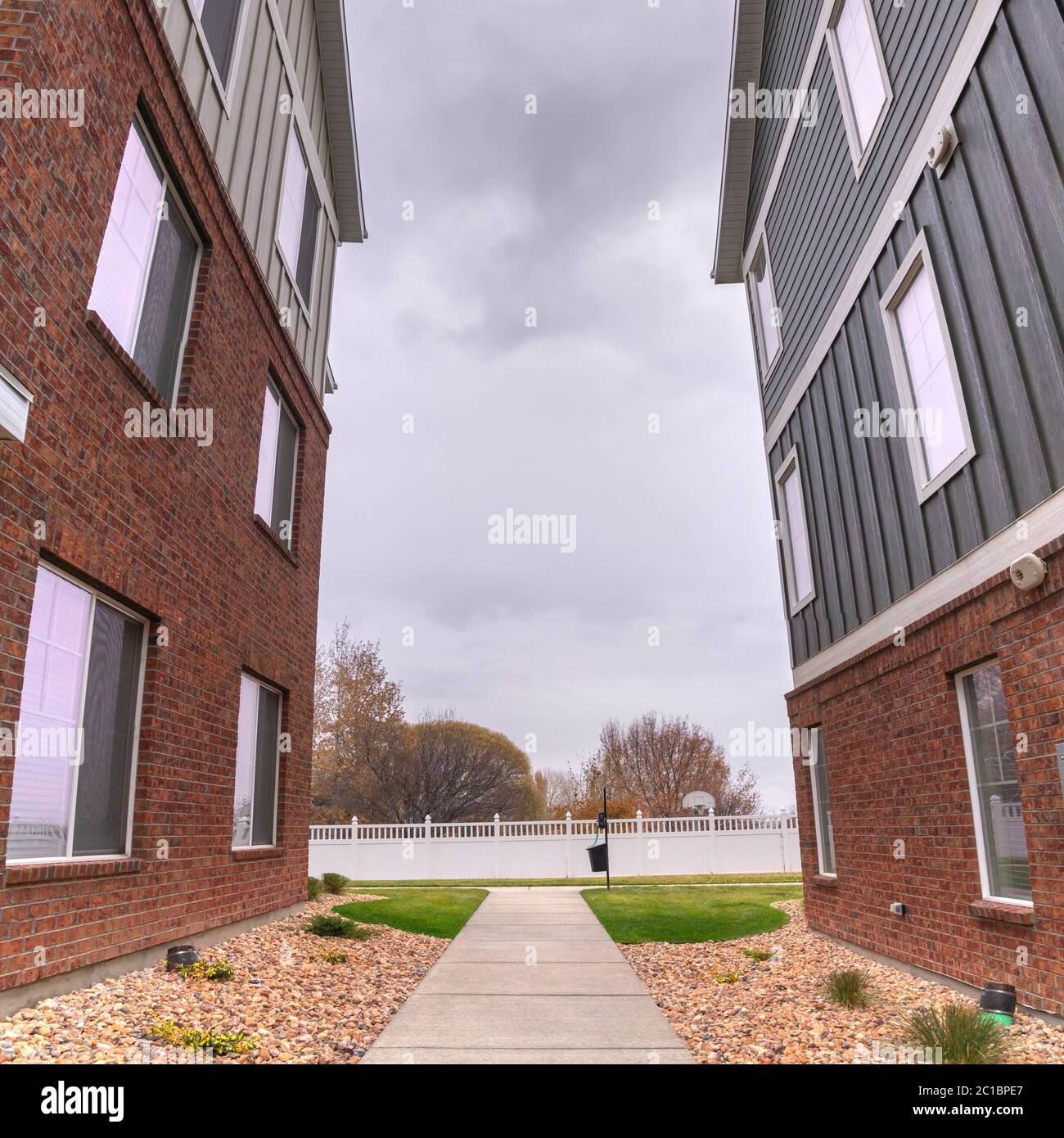 Square frame Narrow alley and footpath in a housing complex Stock Photo ...