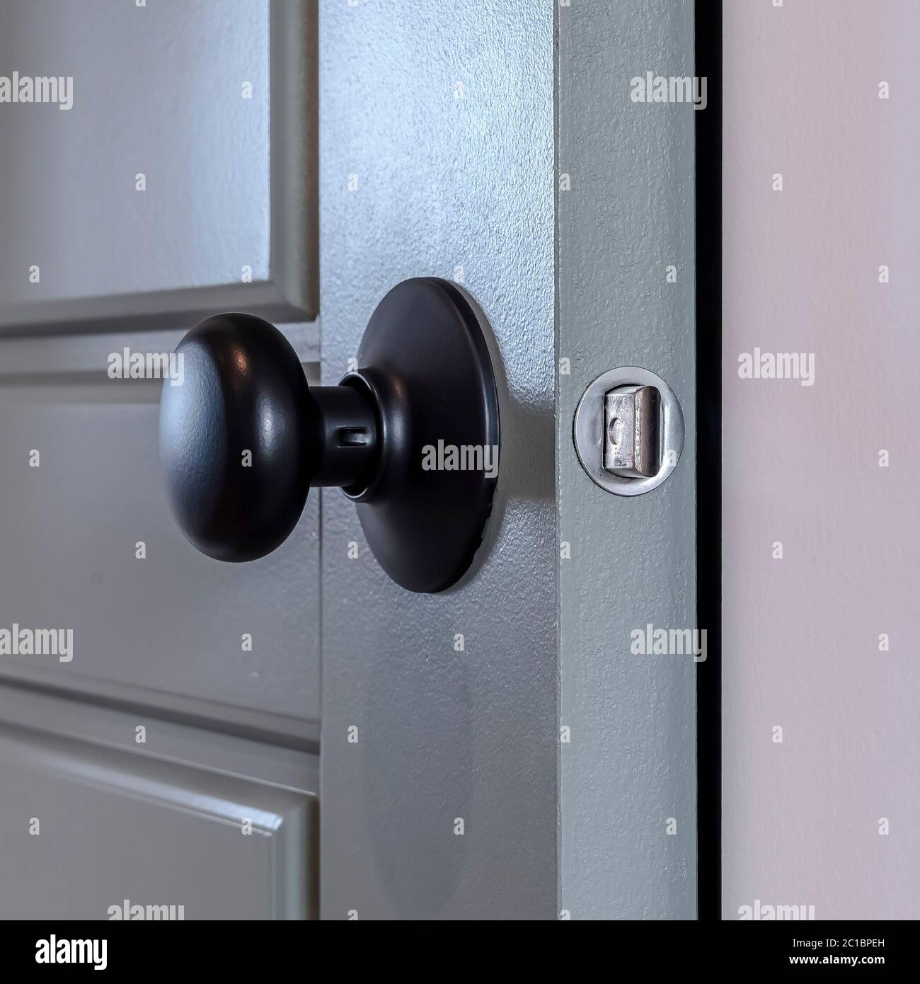 Square frame Hinged panel wooden door with round black door knob and ...