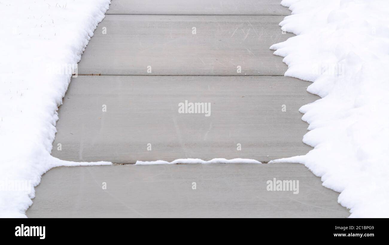Panorama Narrow walkway on ground covered with fresh white snow in ...