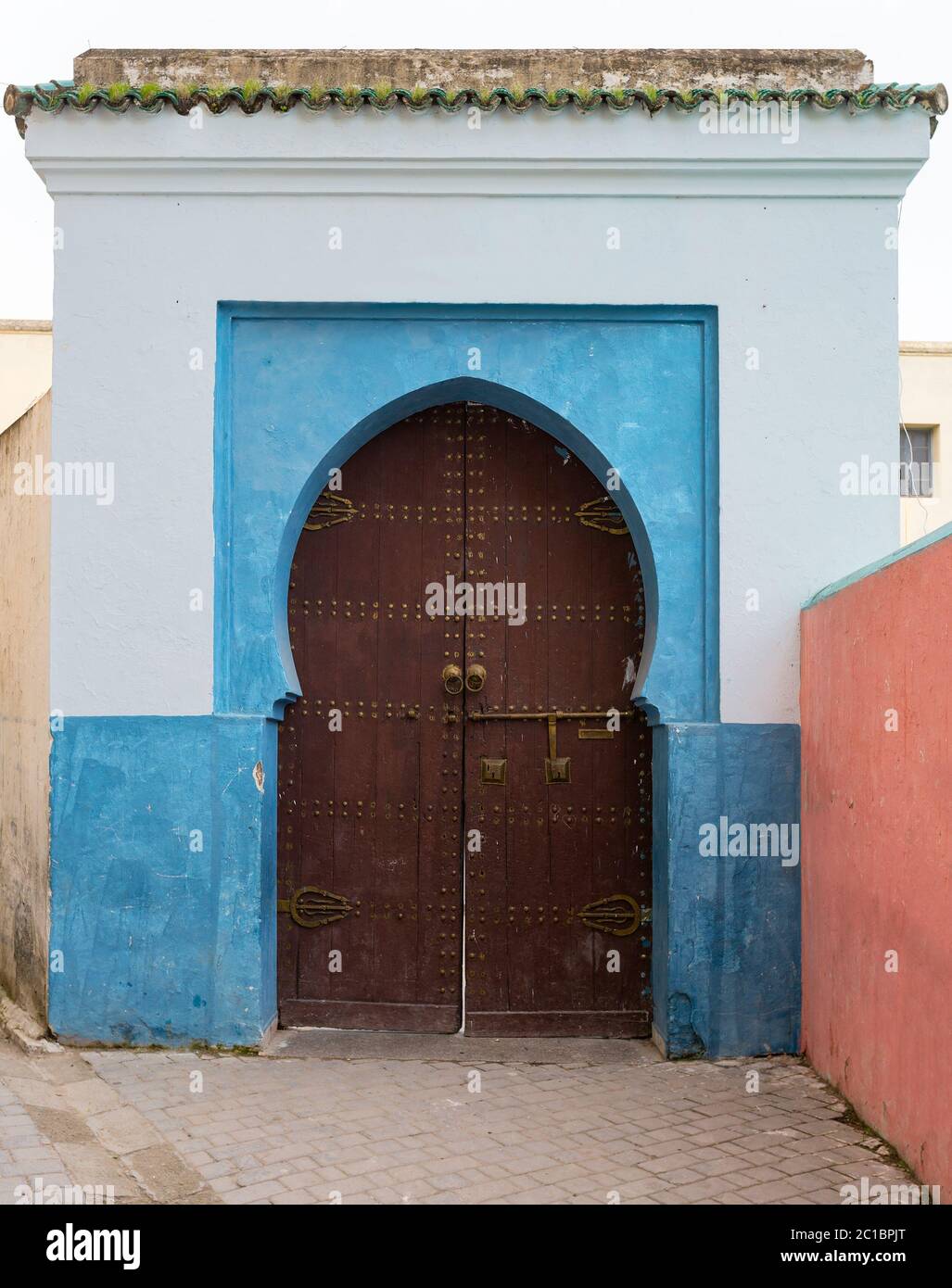 Color entrance gate with door in Fes Stock Photo - Alamy