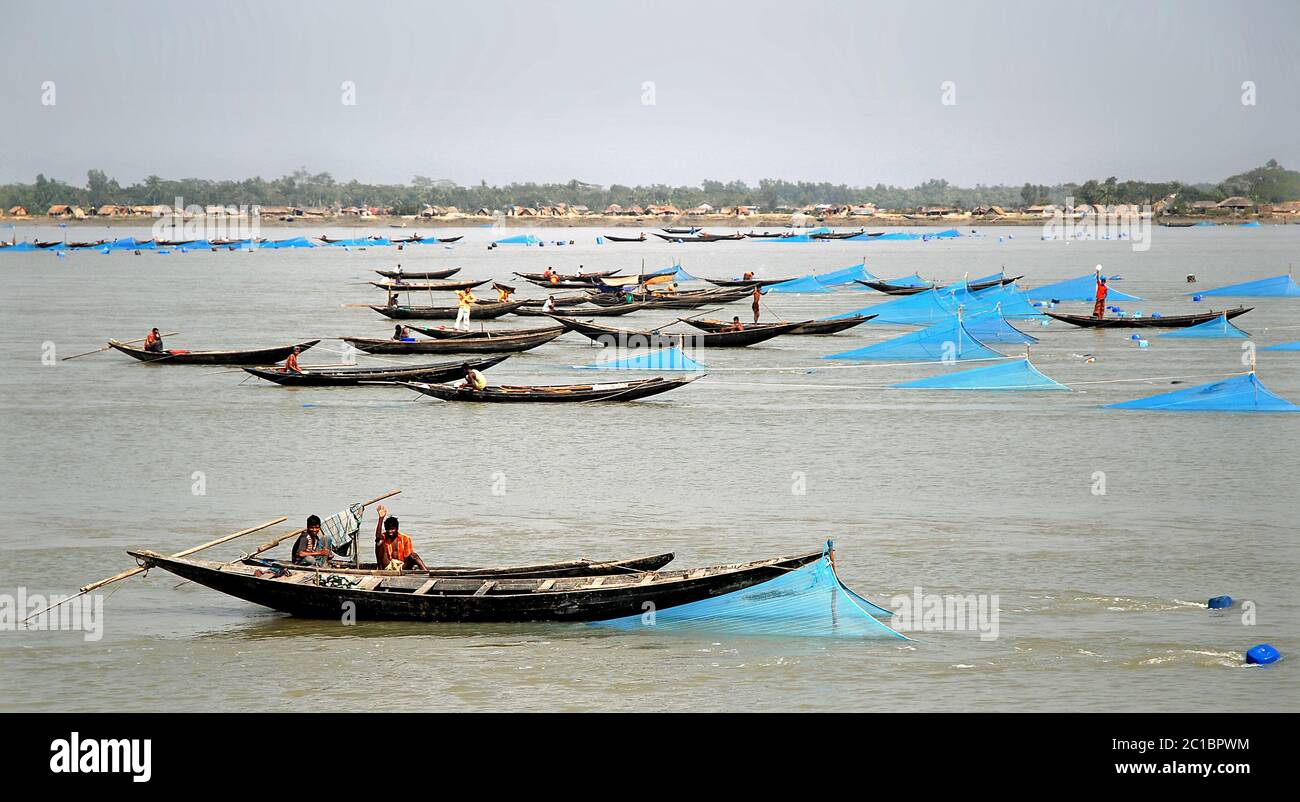 Pashur River near Mongla, Bangladesh. Fishing boats with nets on the ...