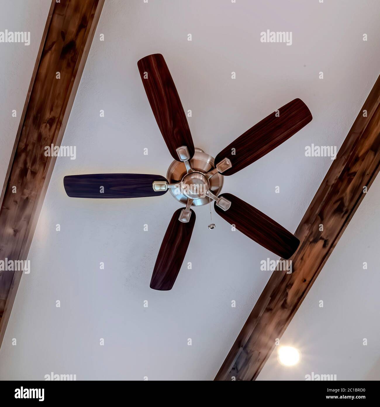 Square frame Living room ceiling fan flanked by decorative wood beams ...
