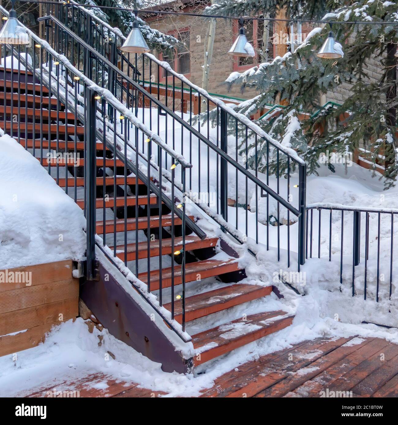 Square crop Stairs and wooden deck on snowy hill with decorative and ...