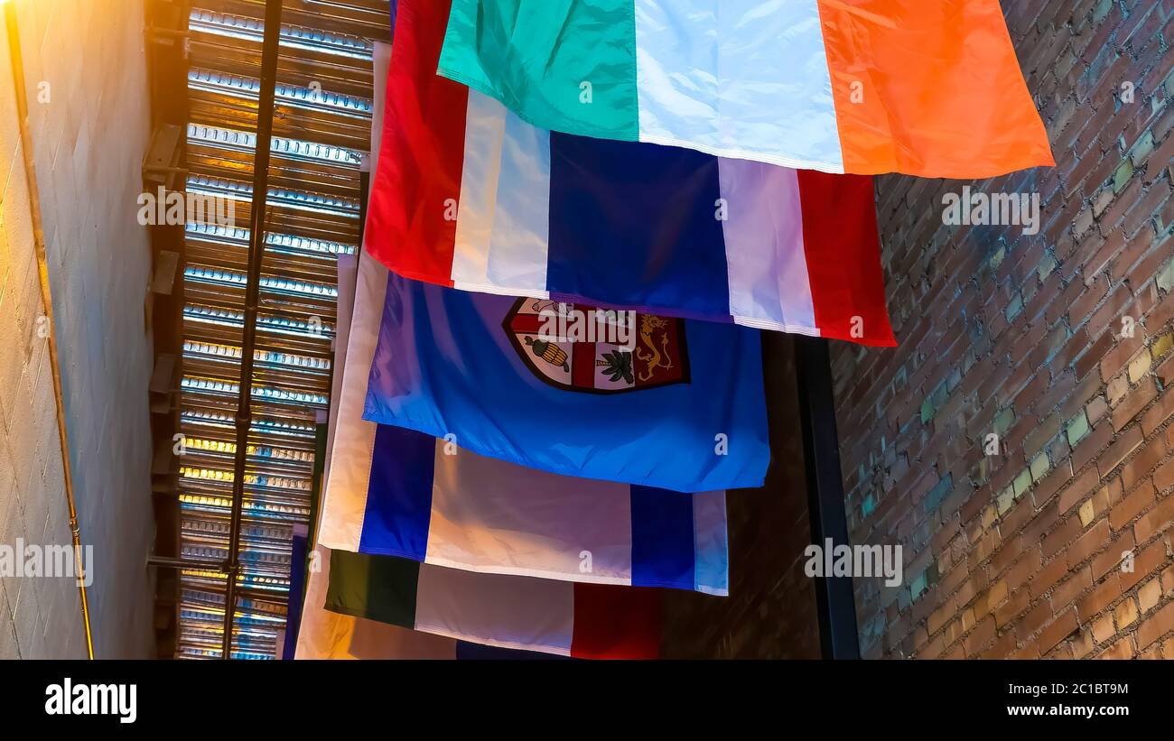 Panorama Vibrant colorful decorative flags against corrugated metal ...