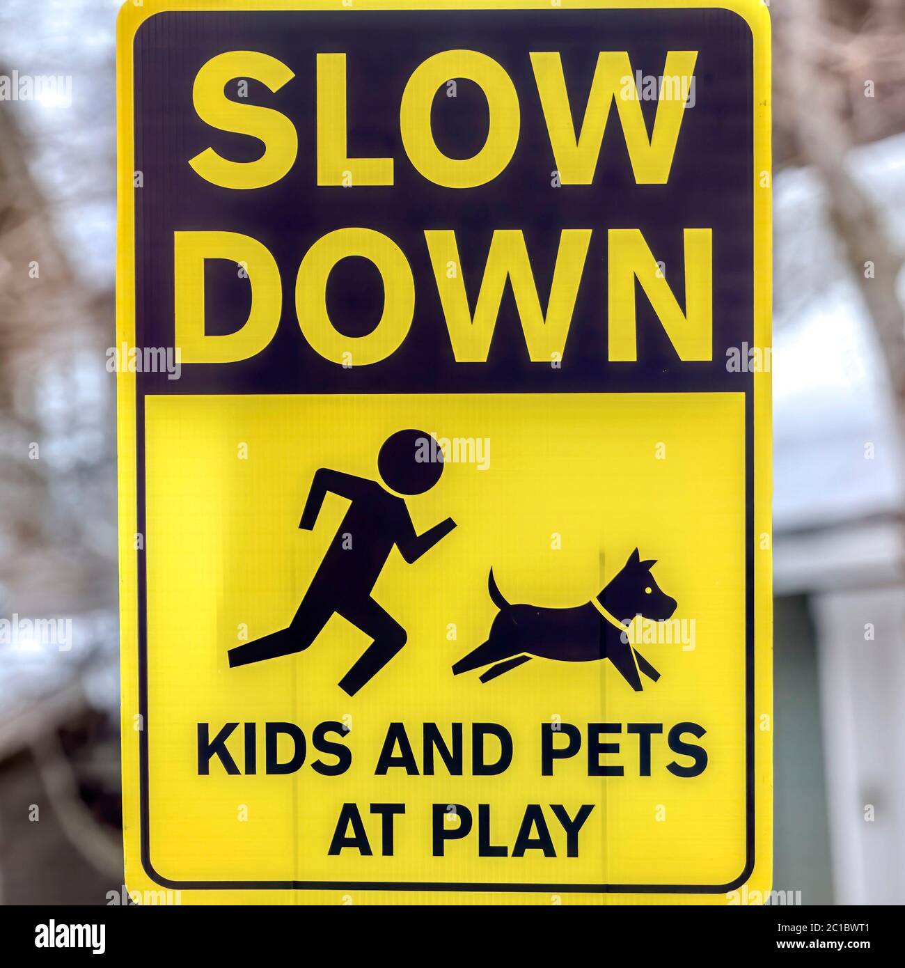 Square Black and yellow Slow Down Kids And Pets At Play sign against ...
