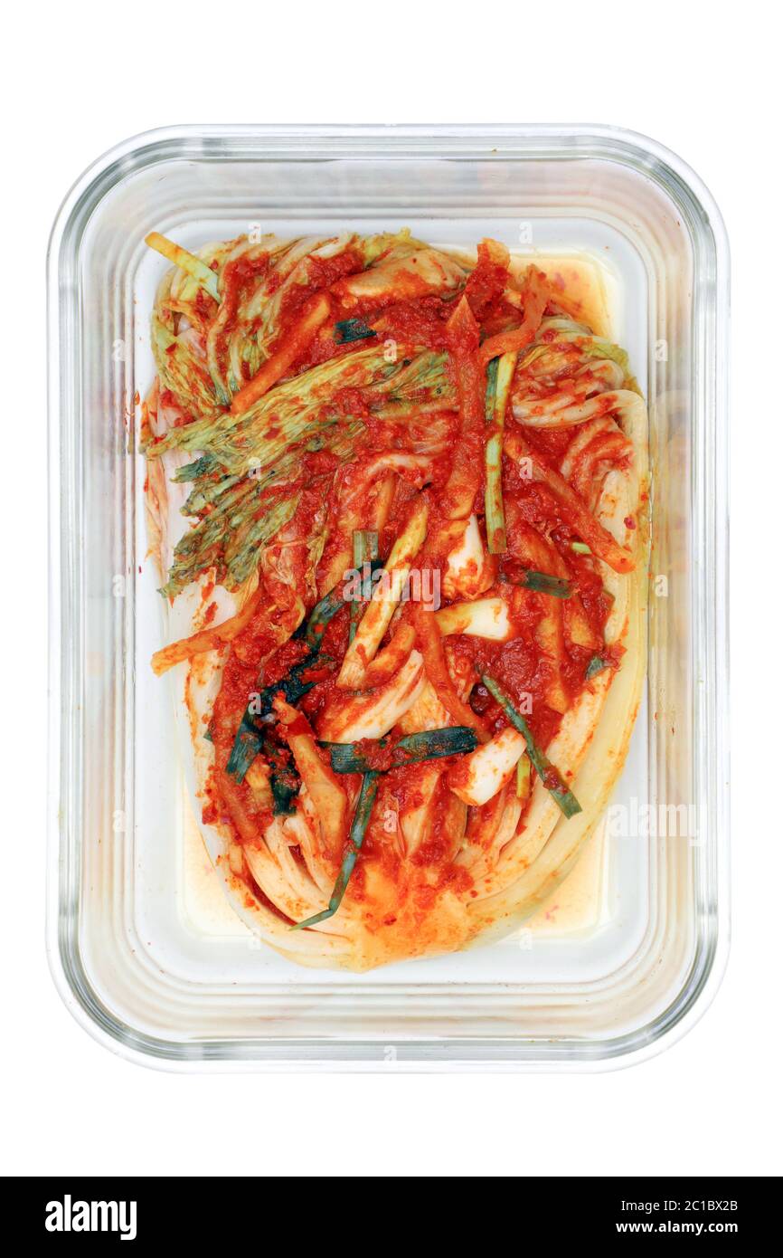 Kimchi cabbage in a glass rectangular bowl isolated in white background ...