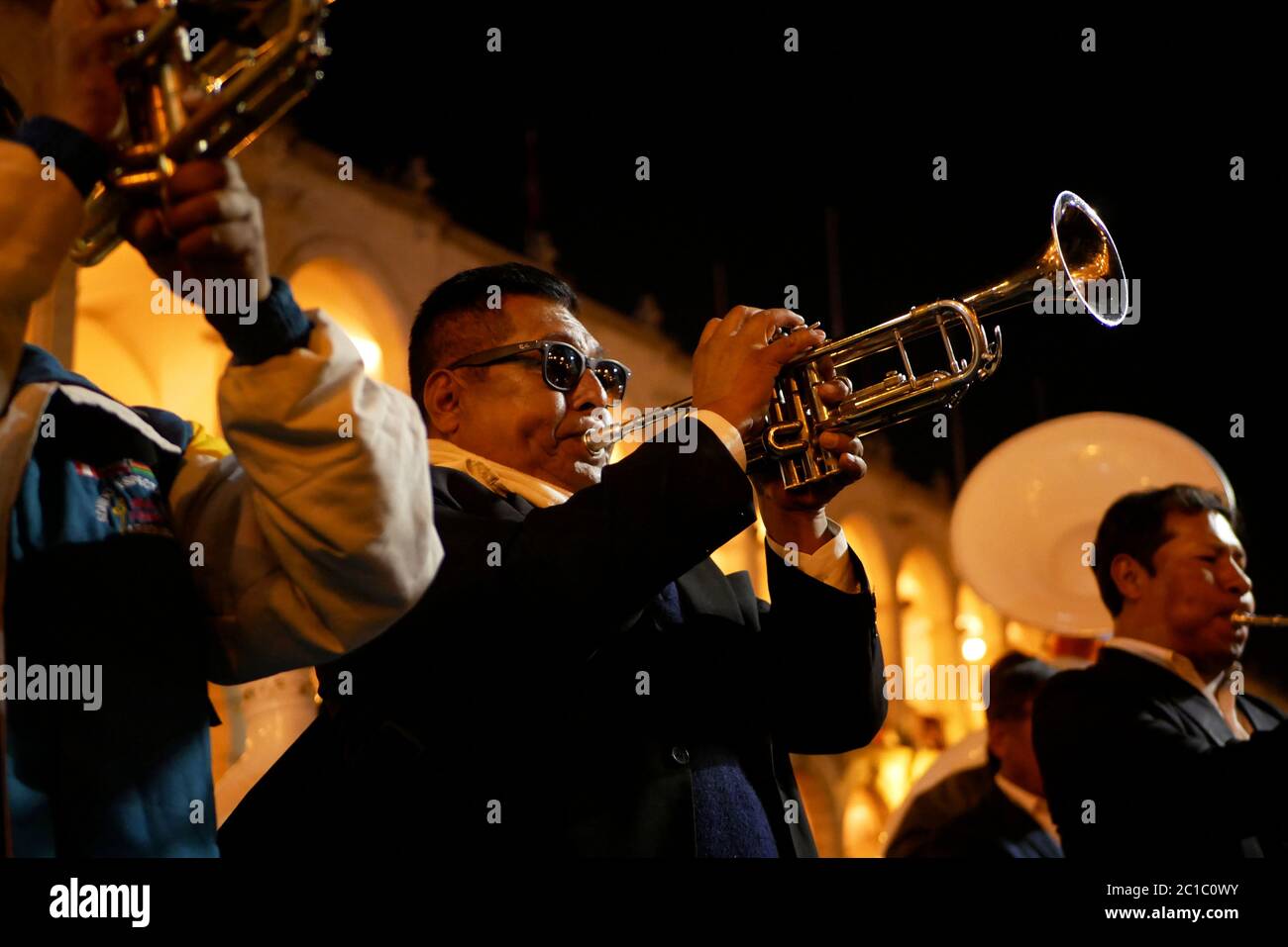 The man from the orchestra plays trumpet during the parade while ...