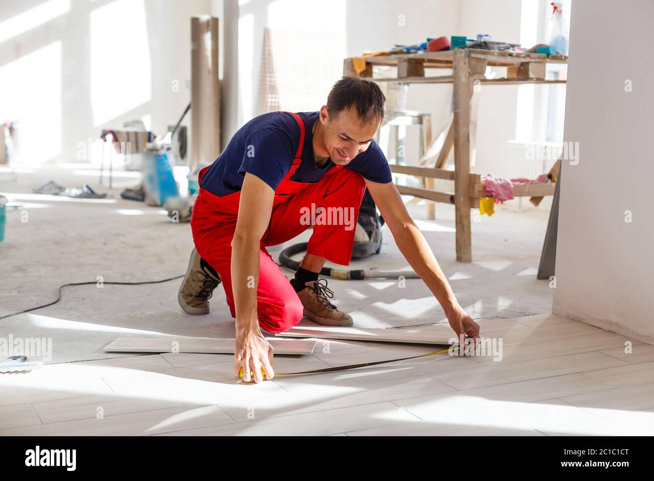 Worker checking level laying tiles hi-res stock photography and images ...