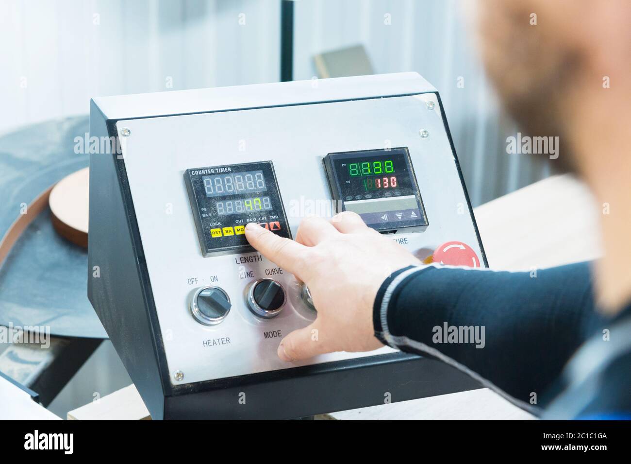 a close-up of the operator the man presses the button on the control ...