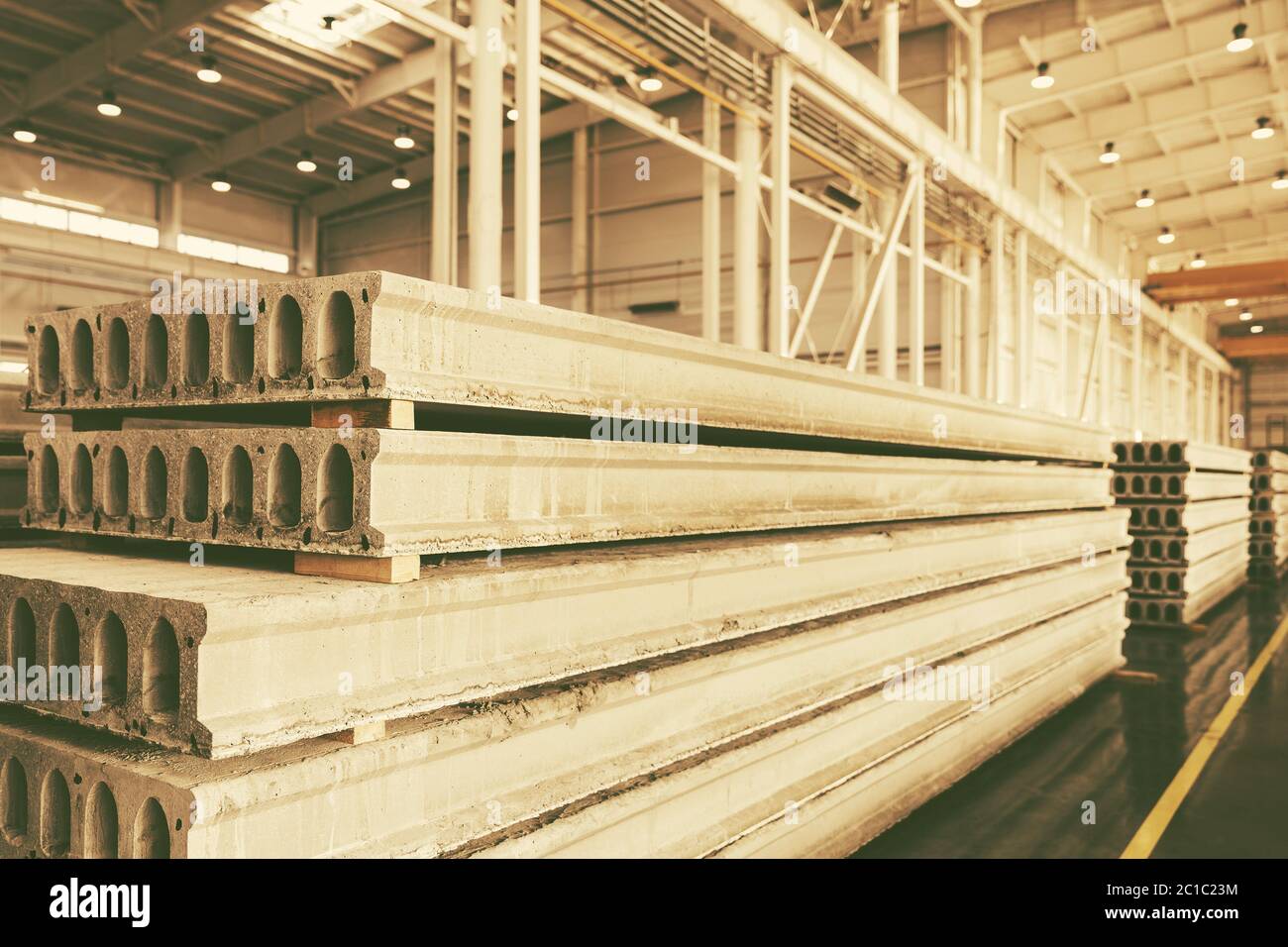 Stack of precast reinforced concrete slabs in a house-building factory ...
