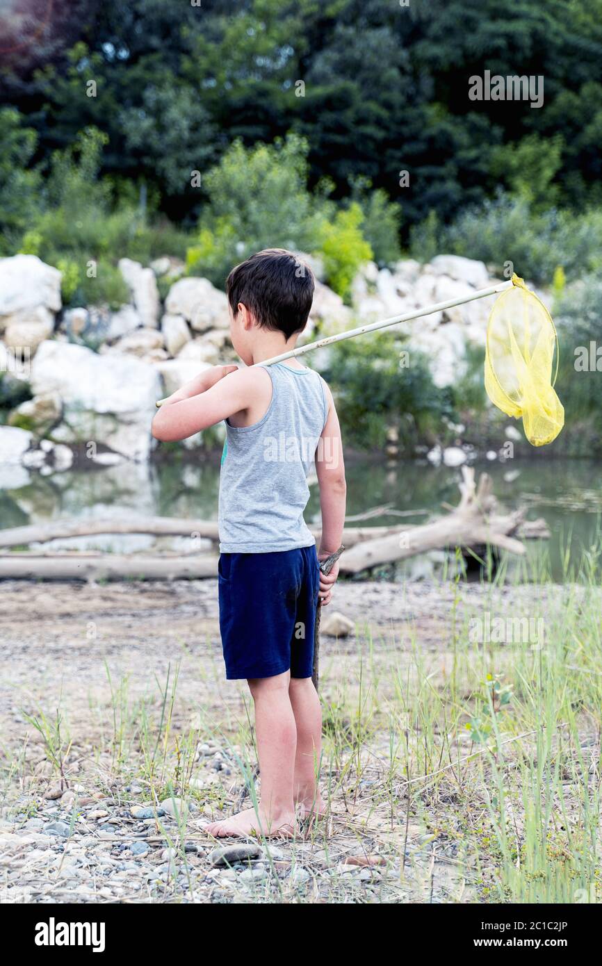 Boy butterfly net grass hi-res stock photography and images - Alamy