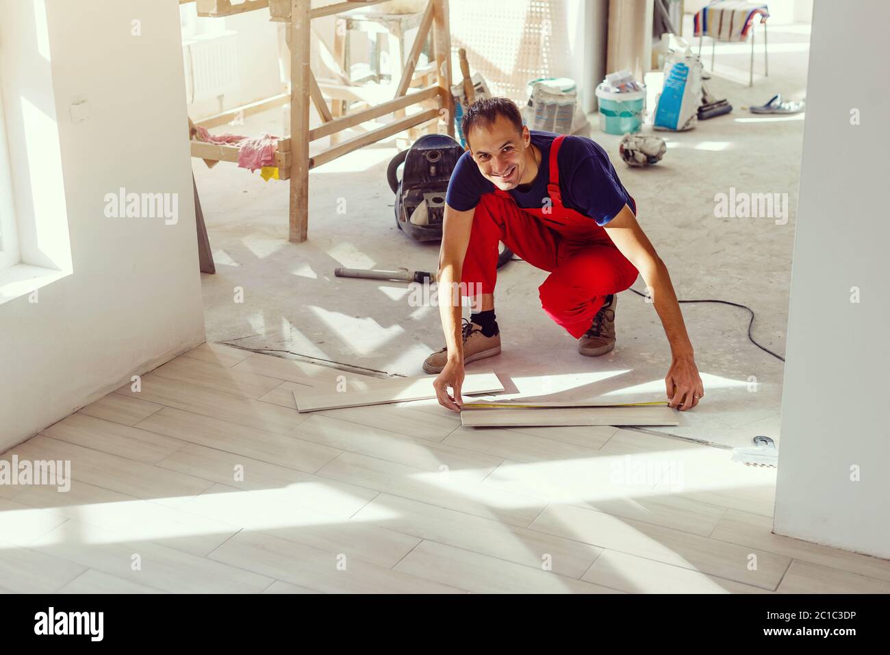 Installing ceramic floor tiles - measuring and cutting the pieces ...