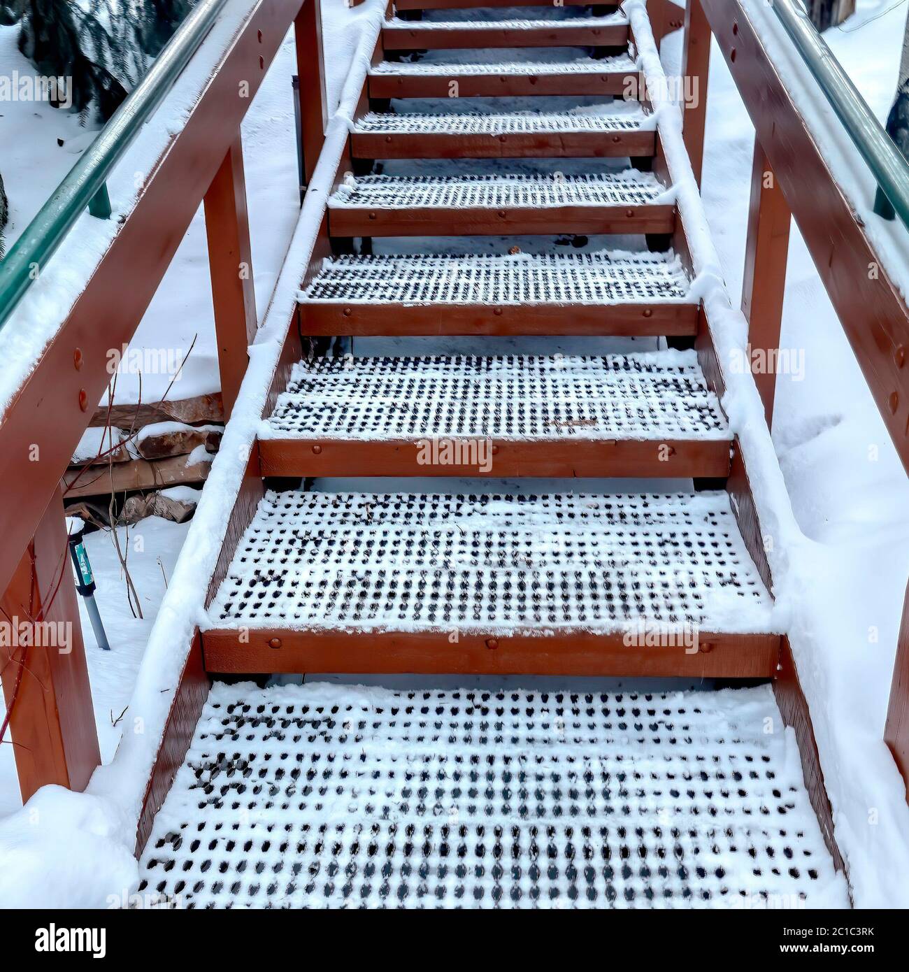 Square Focus on stairs with grate treads and metal handrails against ...