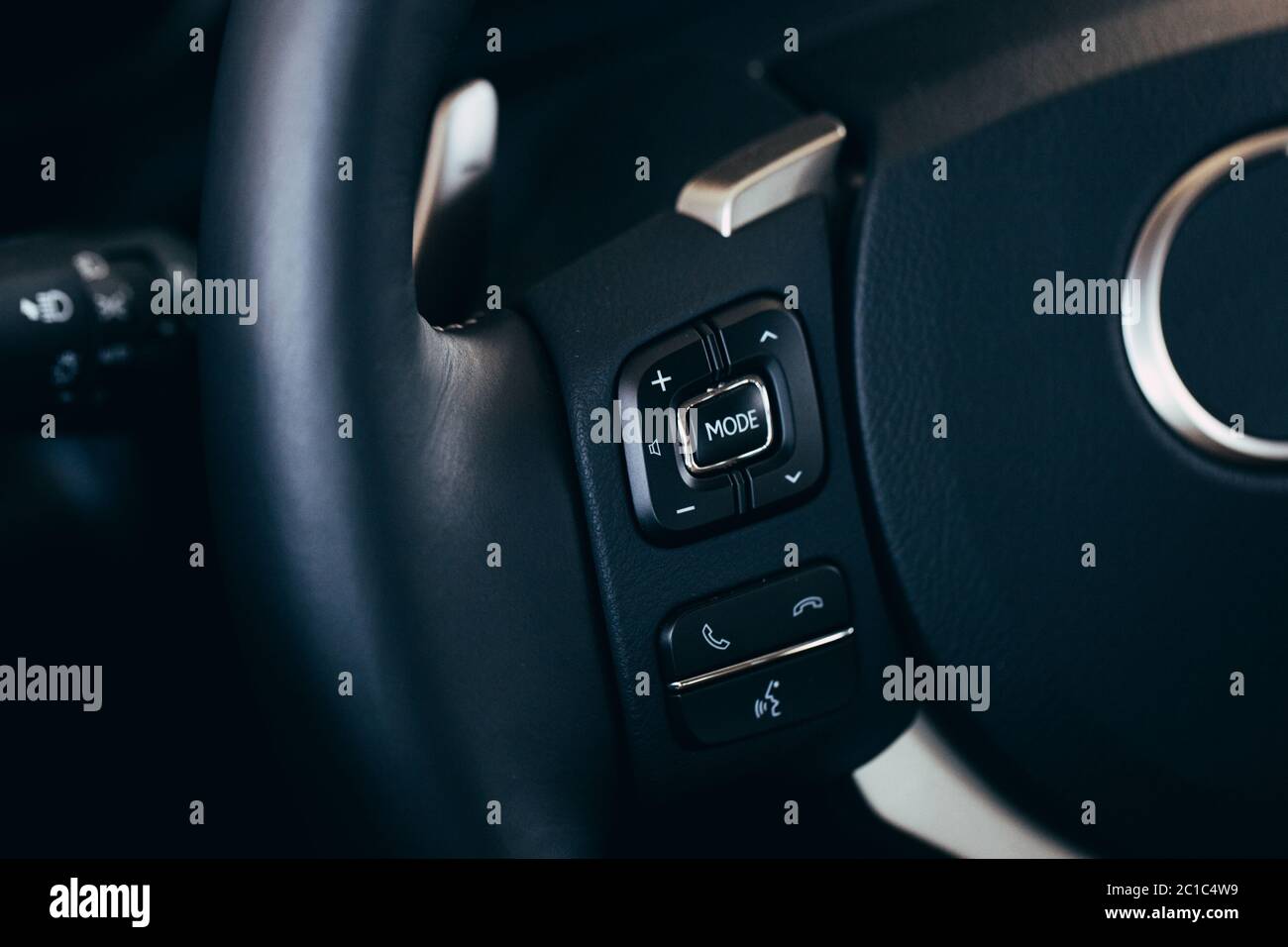 close up Modern black steering wheel with multifunction buttons ...