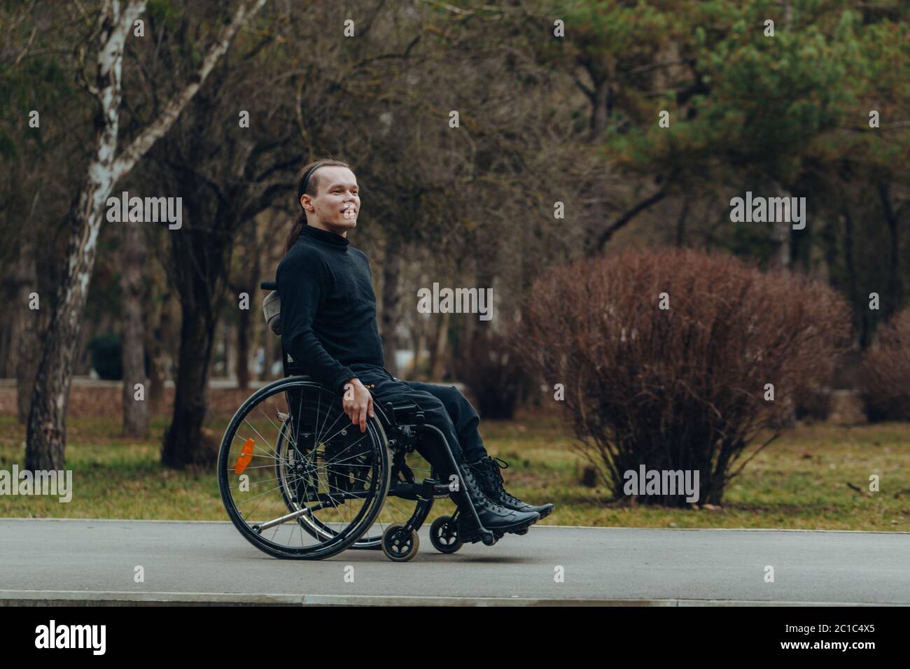 Disabled person in wheelchair walking hi-res stock photography and ...