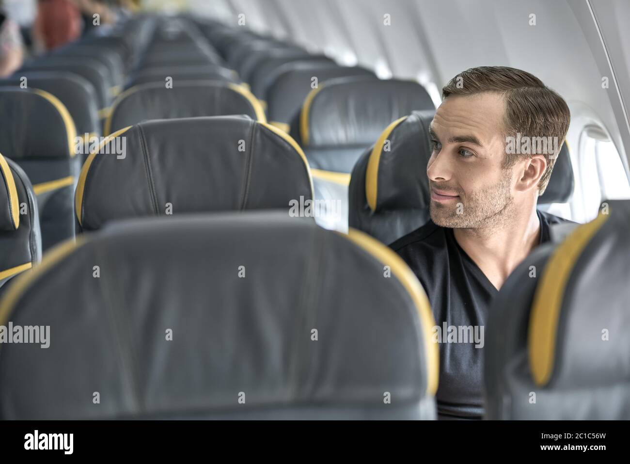 Airplane seat man smiling hi-res stock photography and images - Alamy