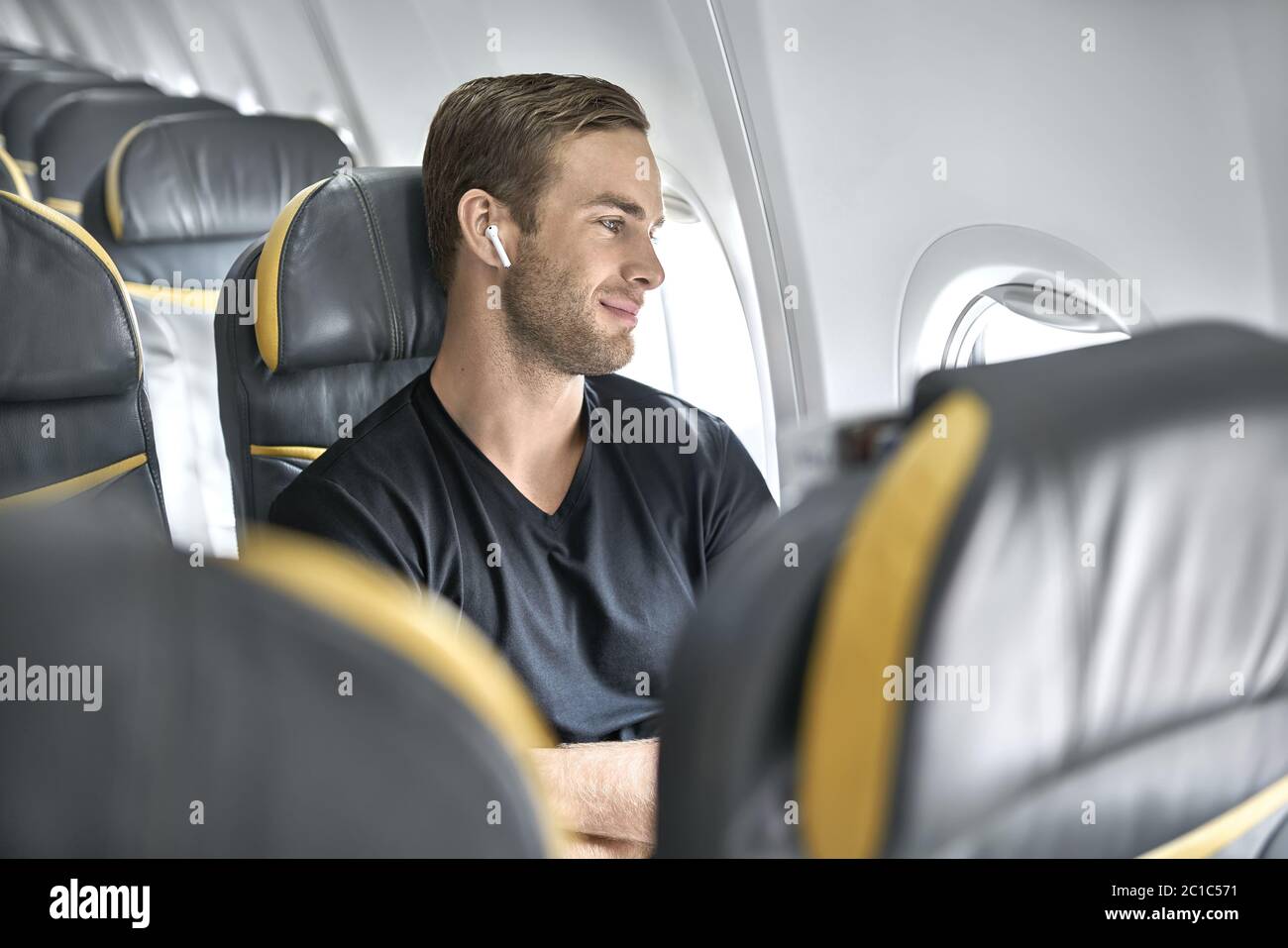 Handsome guy in airplane Stock Photo - Alamy