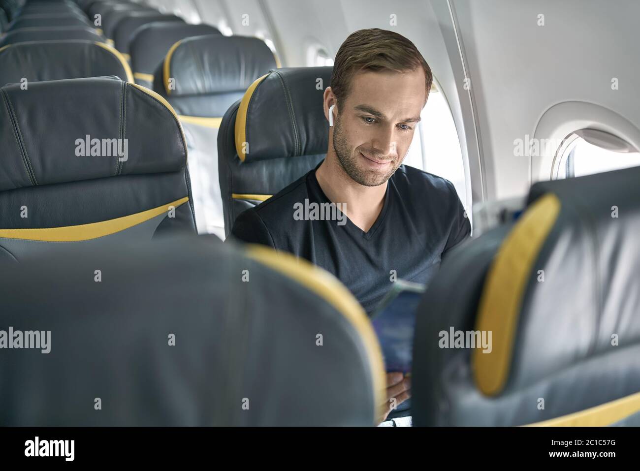 Handsome guy in airplane Stock Photo - Alamy