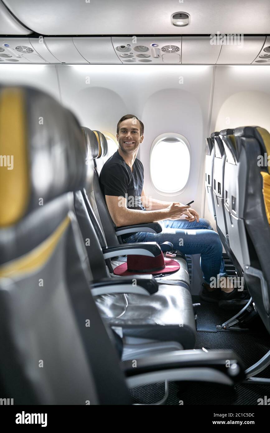 Handsome guy in airplane Stock Photo - Alamy