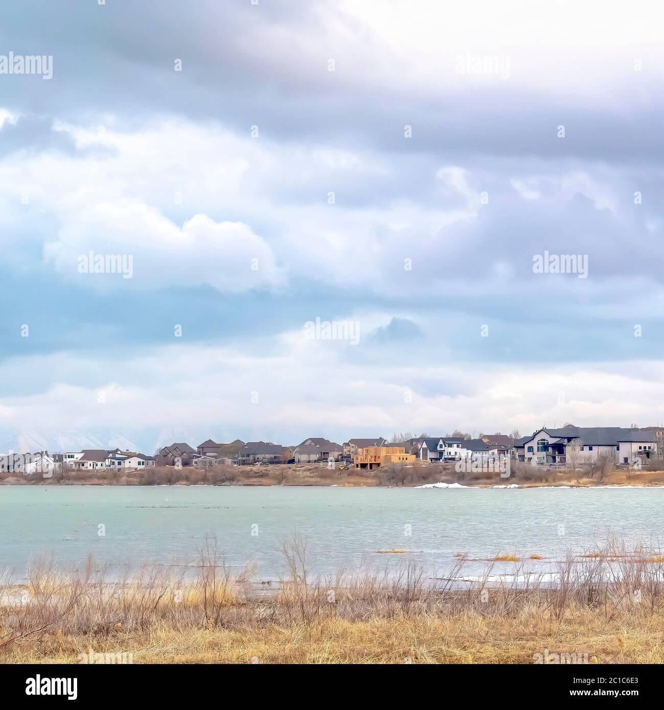 Square crop Scenic lake landscape with residences by the shore beneath ...