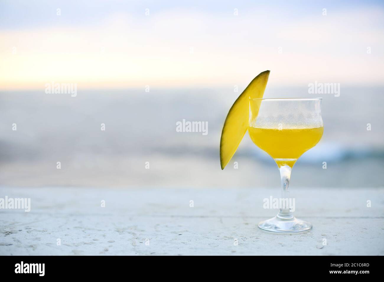 Glass of mango cocktail on bar counter Stock Photo - Alamy