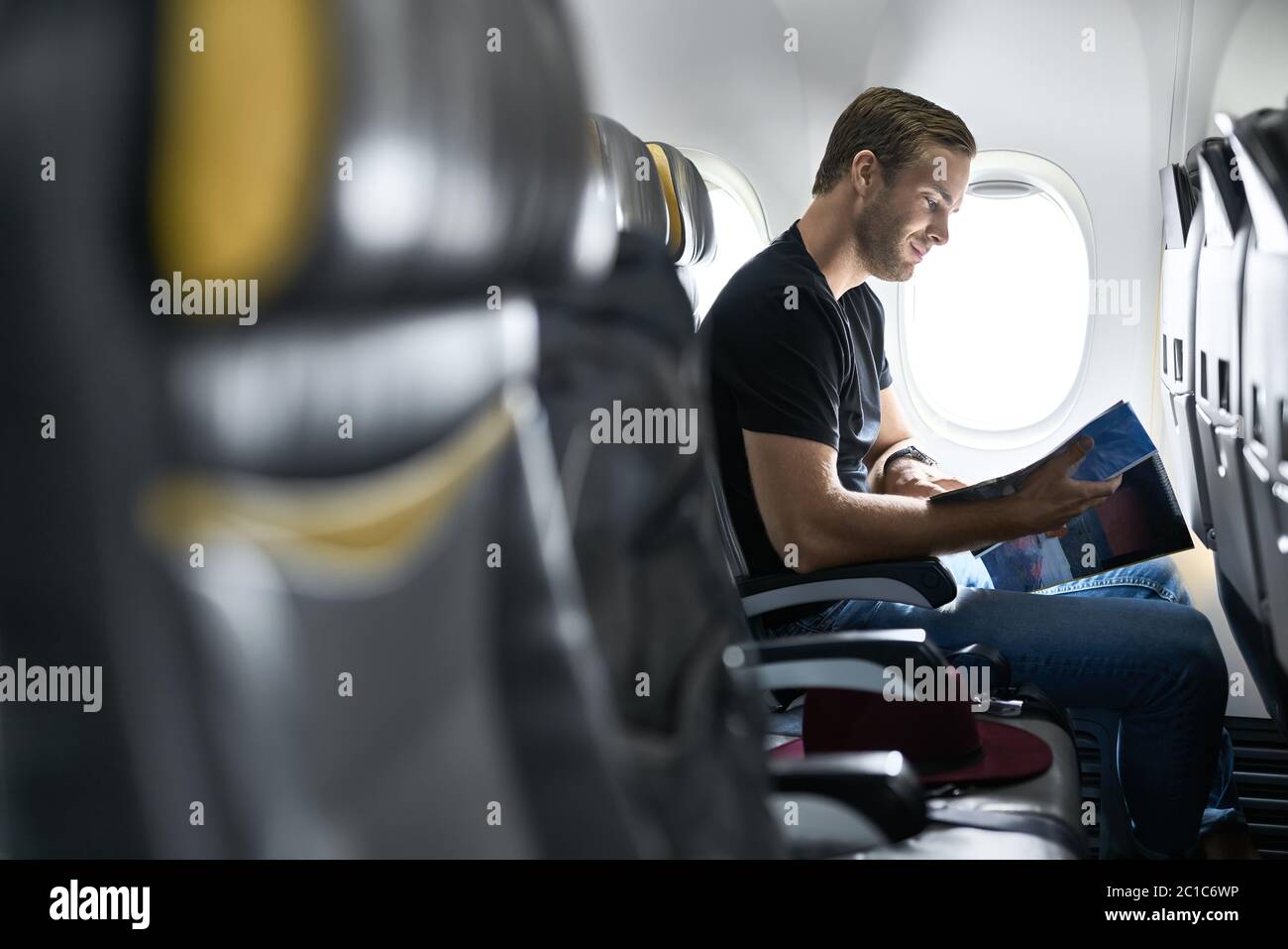 Male tourist sitting in airplane hi-res stock photography and images ...