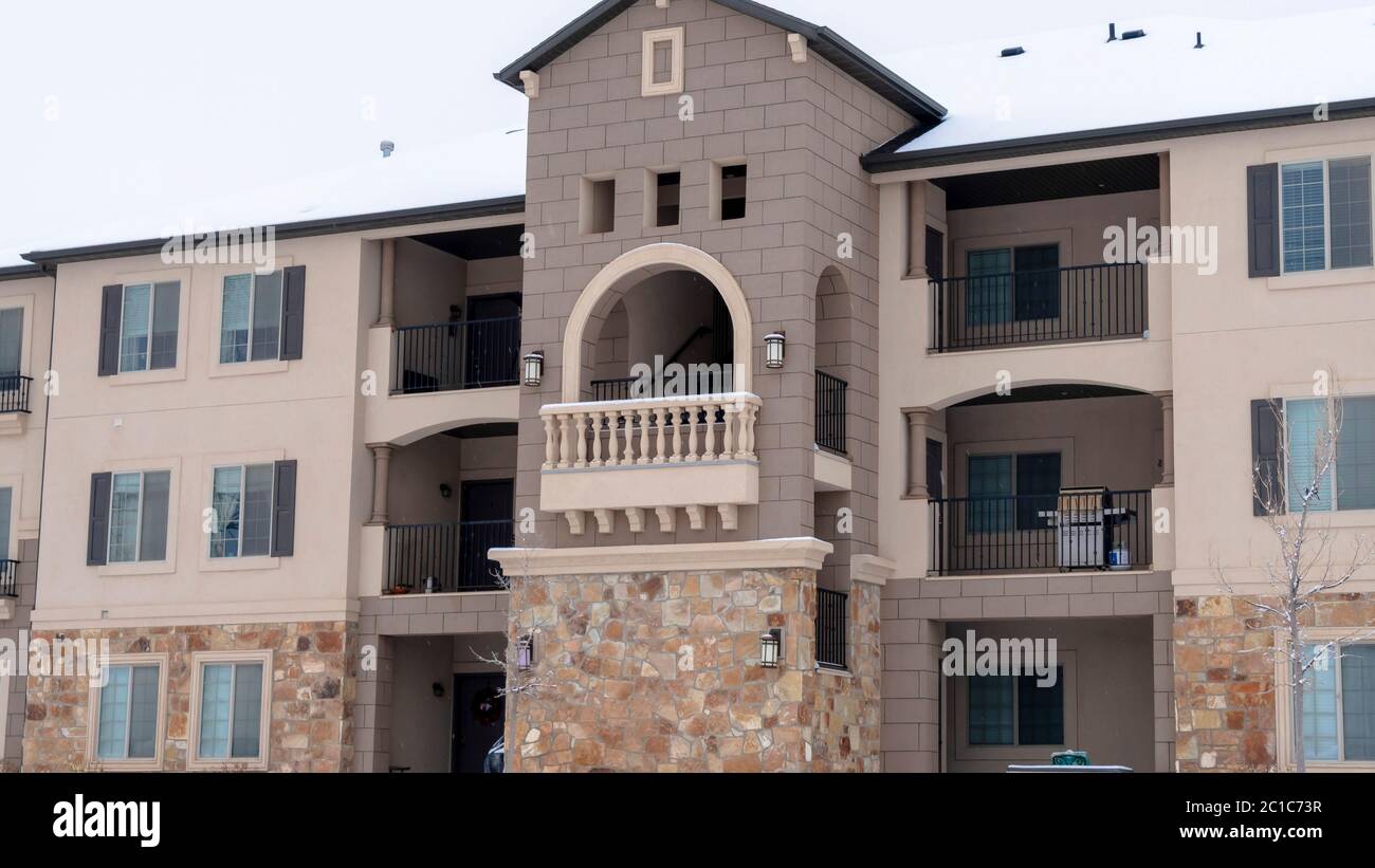 Panorama crop Facade of apartments with gabled arched balcony at the ...