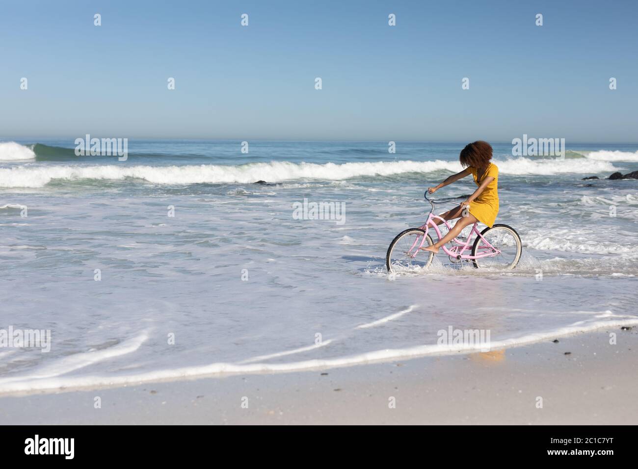 Woman riding bike on beach hi-res stock photography and images - Alamy