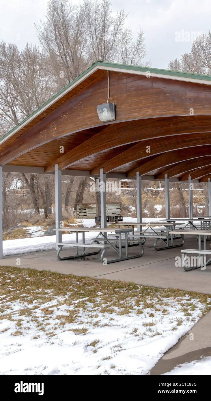 Vertical Pavilion with wooden arches on the ceiling amid park covered ...