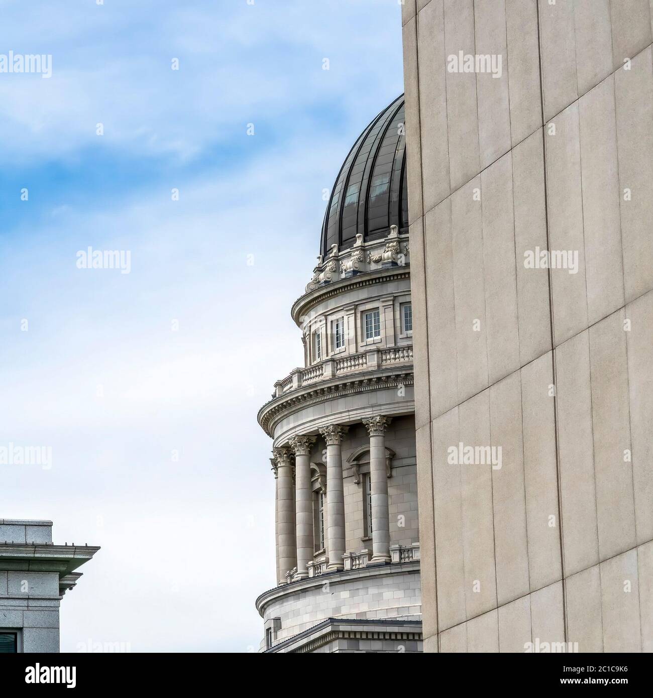 Square Utah State Capital building and dome viewed behind a stone ...