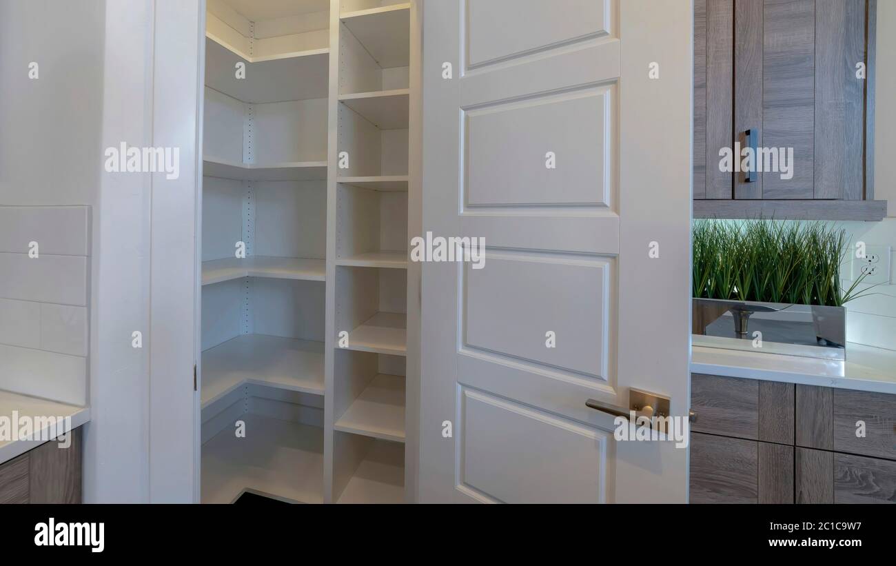 Panorama frame Small pantry with empty wall shelves at the corner of ...