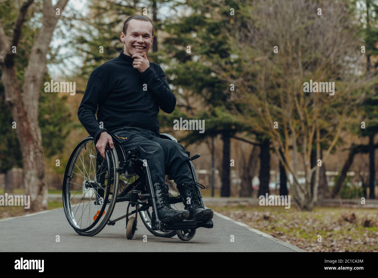 young disabled man in wheelchair walking park Stock Photo - Alamy