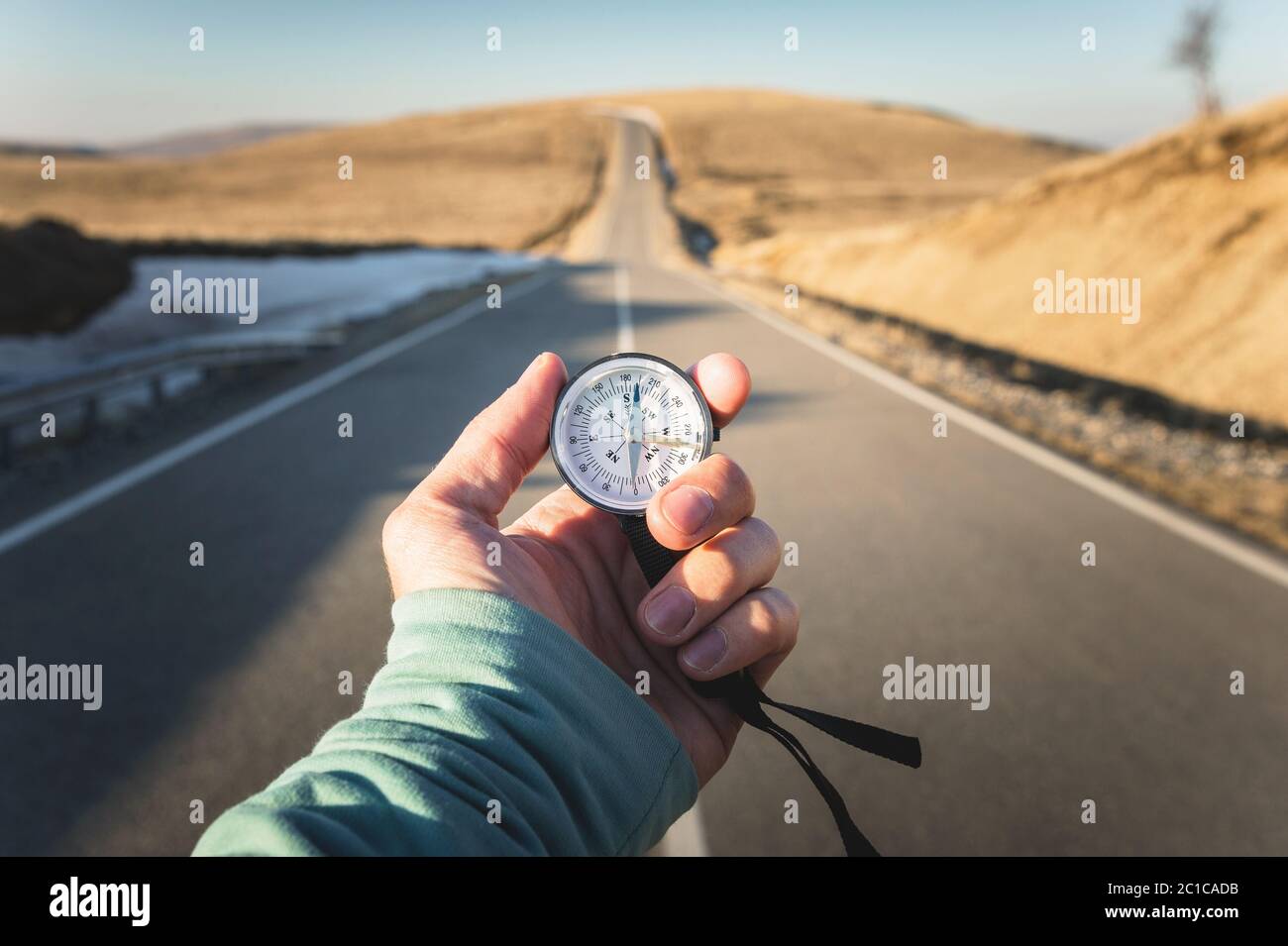 Compass in Hand mountain road background .Vintage Tone Stock Photo - Alamy