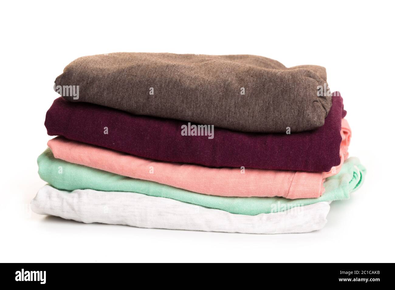 stack of clothing isolated on white background Stock Photo - Alamy
