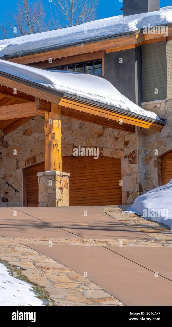 Vertical crop Home in Park City Utah with snowy gable roofs stone wall ...